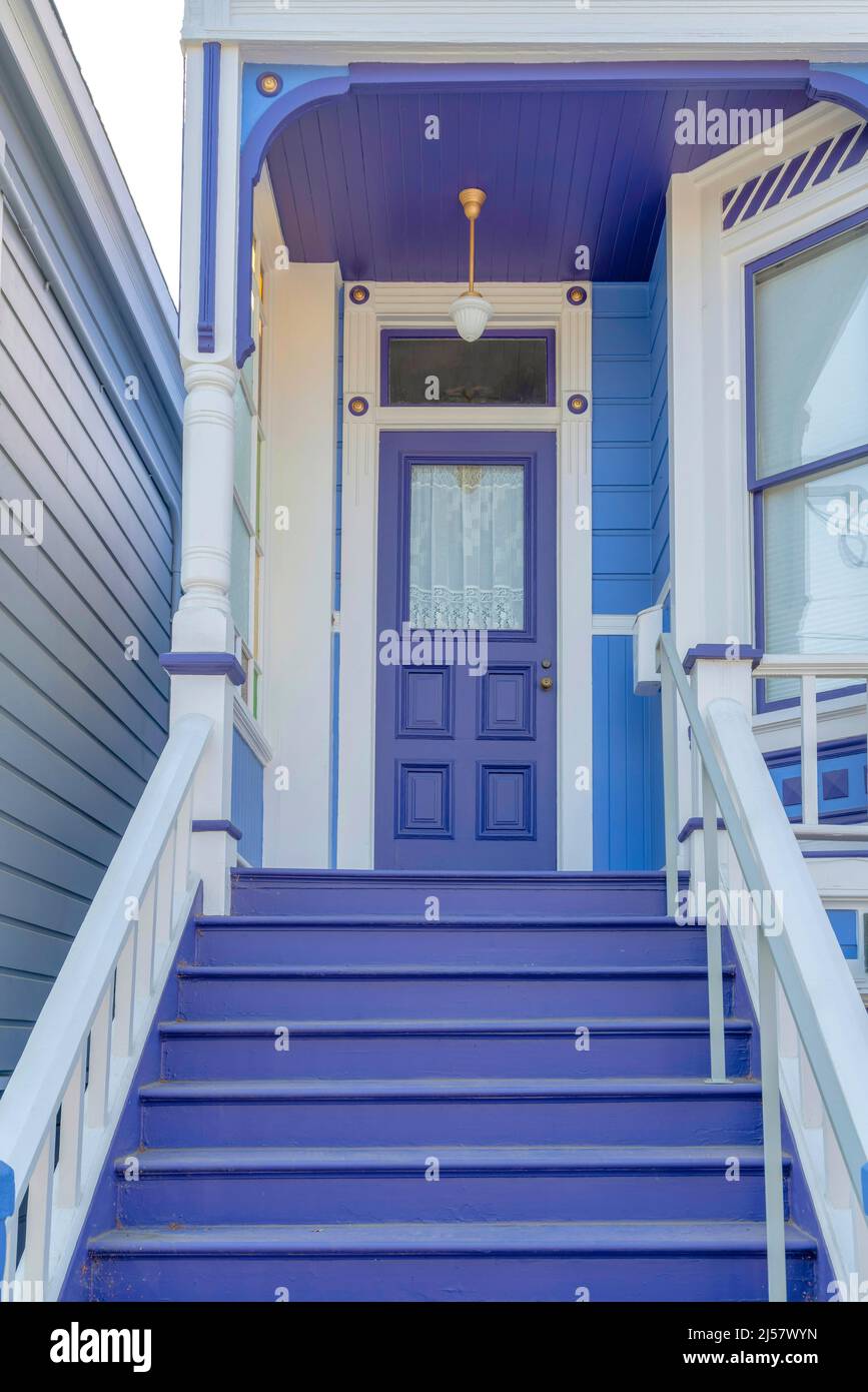 Violet entrance exterior of a house with white trims and railings at ...
