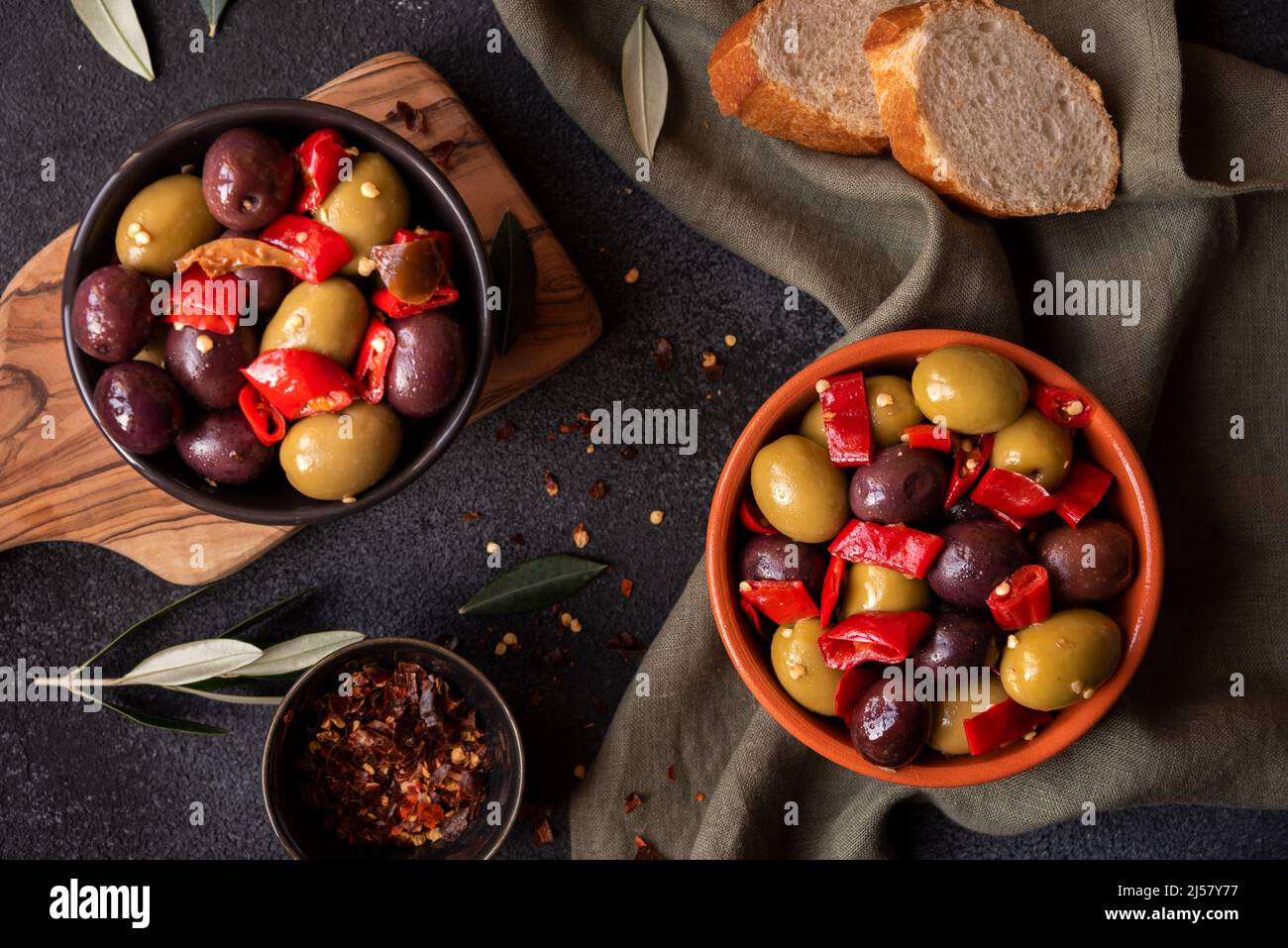 Delicious green and red olives with red chili pepper and olive tree ...