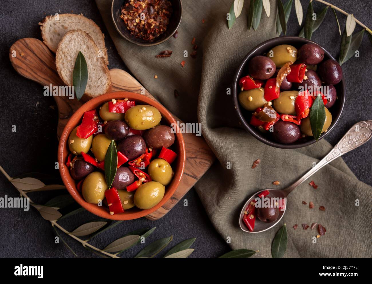 Delicious green and red olives with red chili pepper and olive tree ...