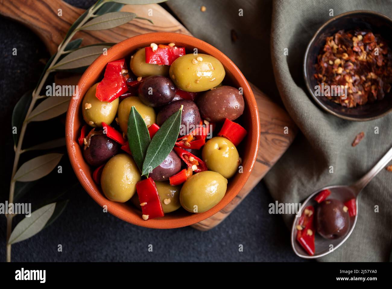 Delicious green and red olives with red chili pepper and olive tree ...