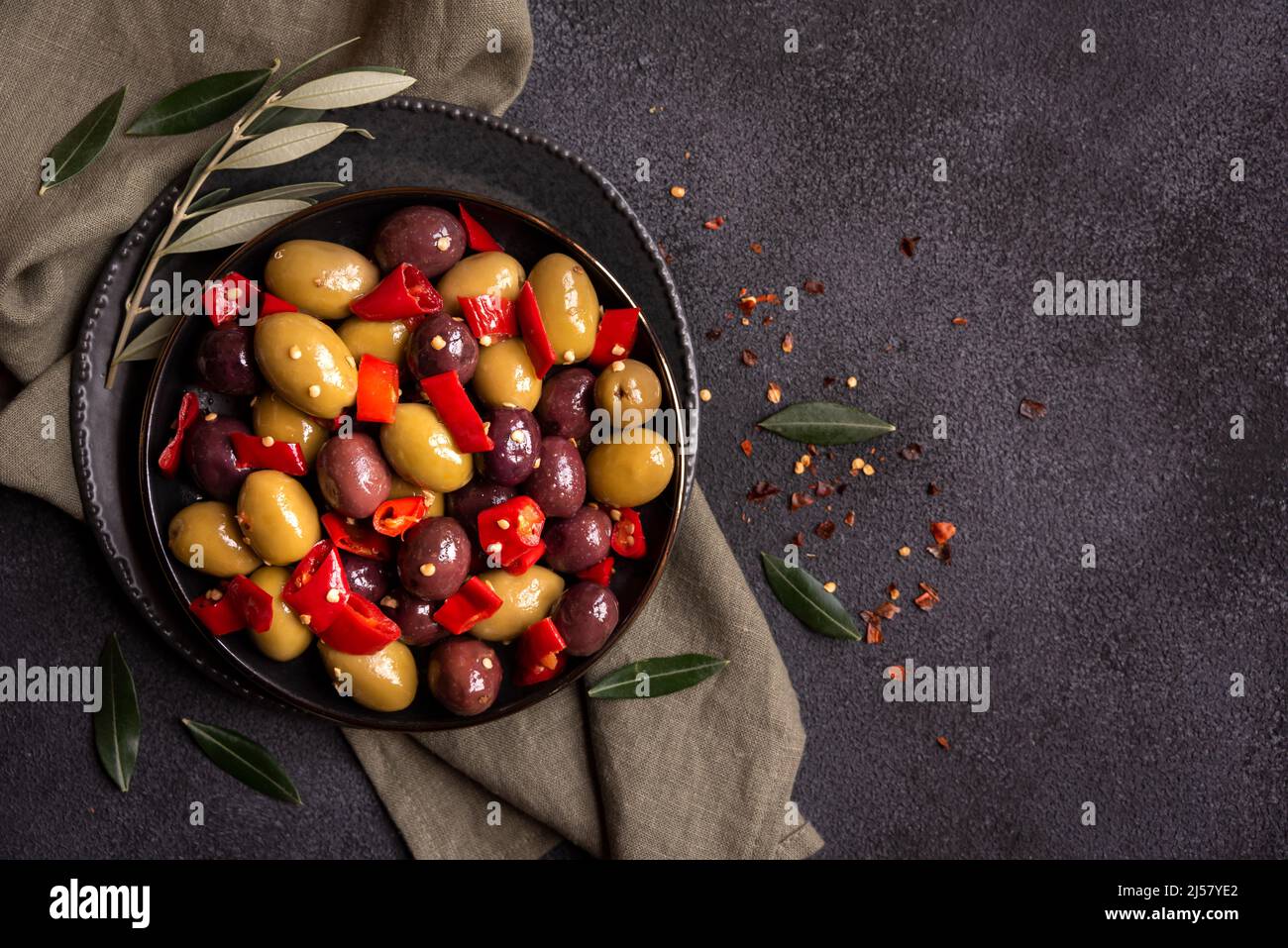 Delicious green and red olives with red chili pepper and olive tree ...