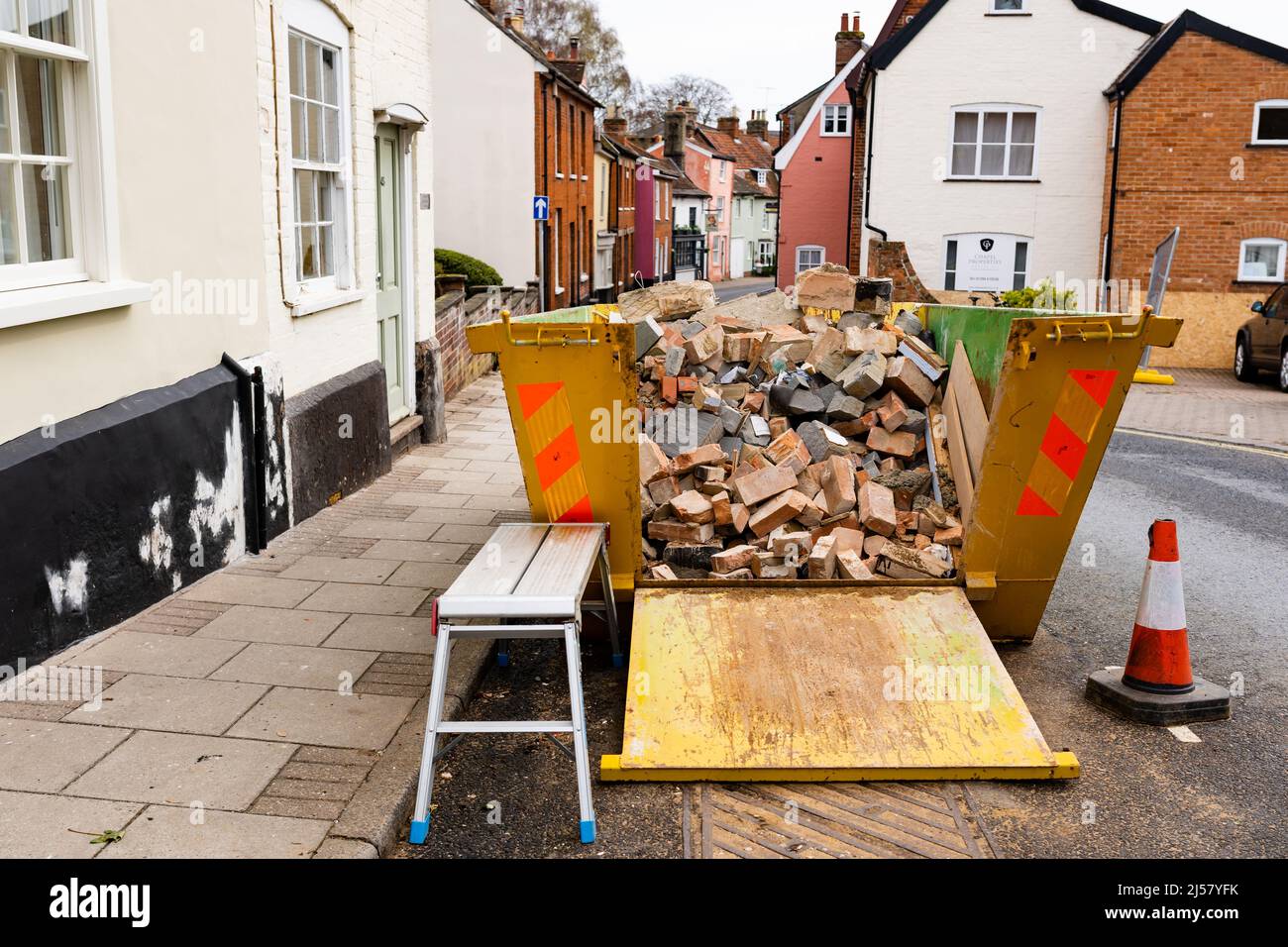 A builders skip containing rubble and bricks from a ongoing home ...