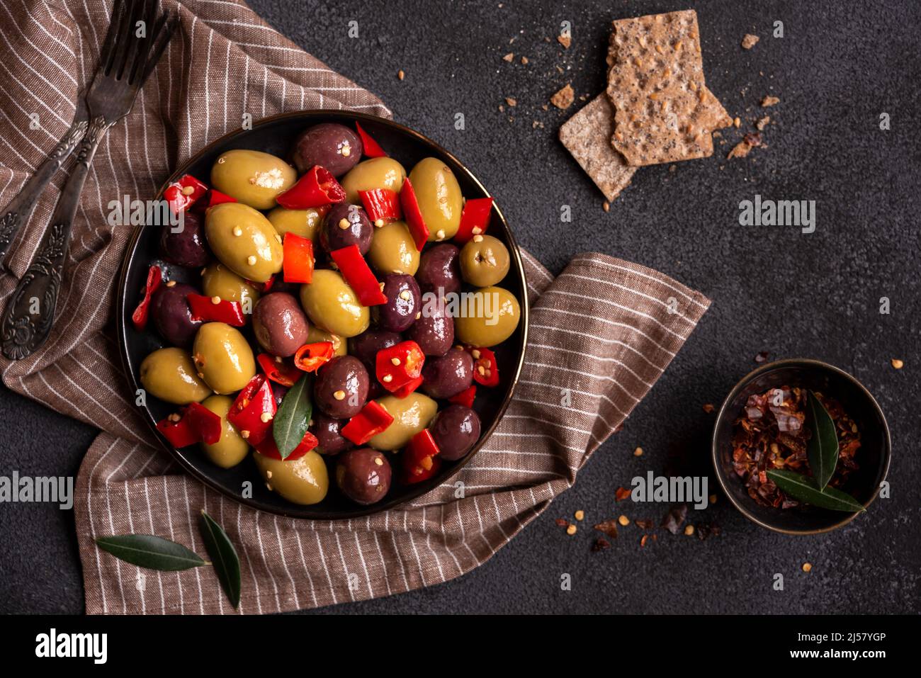 Delicious green and red olives with red chili pepper and olive tree ...