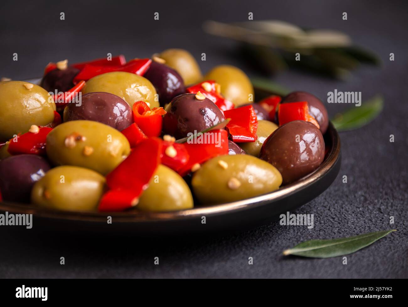 Delicious green and red olives with red chili pepper and olive tree ...