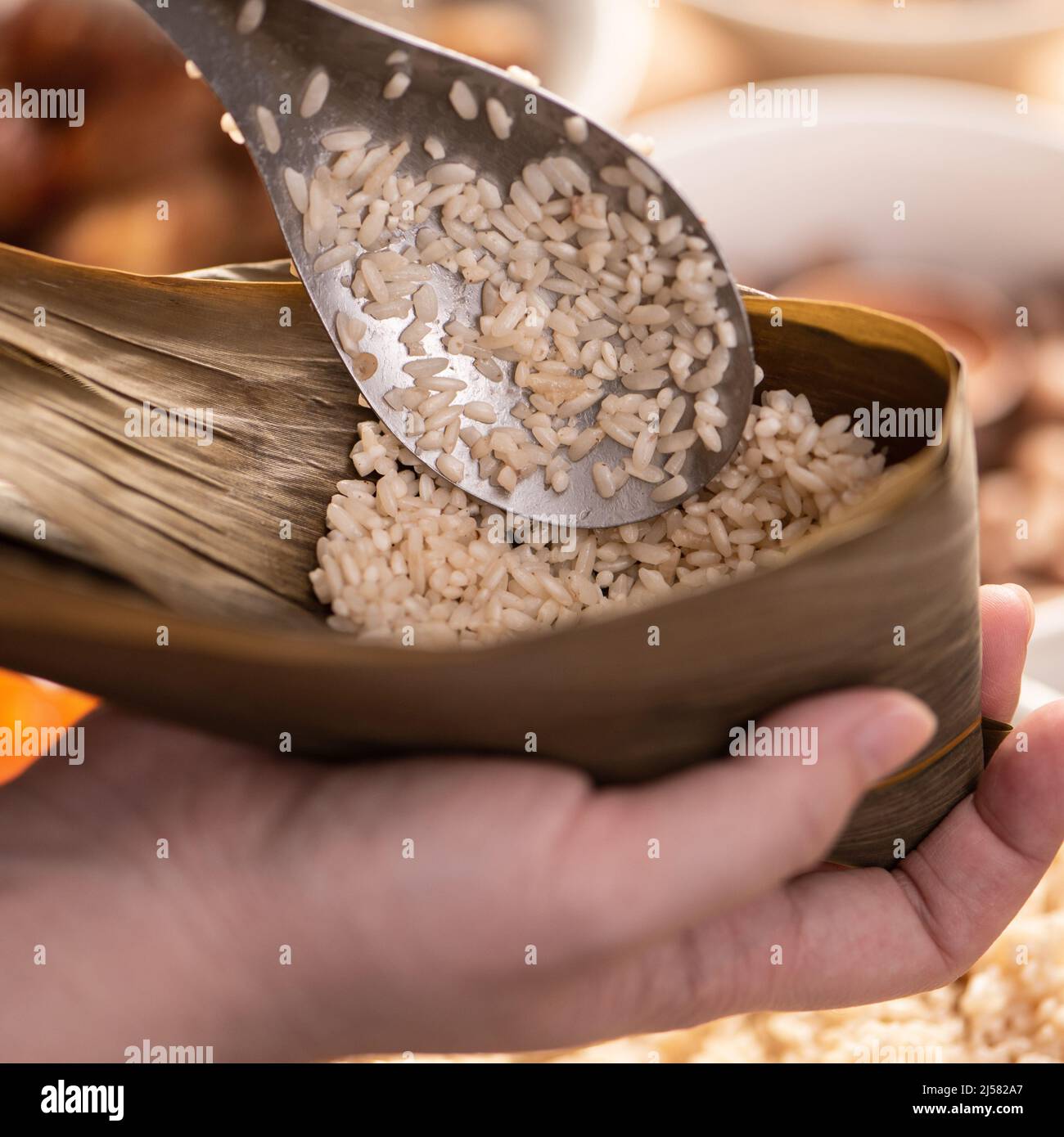 Making zongzi food - preparing and wrapping Chinese rice dumpling at ...