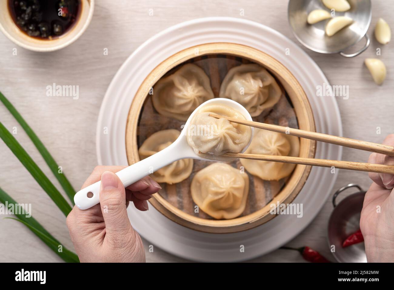 Eating steamed pork soup dumplings named Xiao long bao xiaolongbao in ...