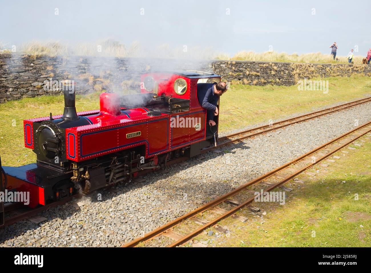 Narrow guage steam locomotive slowly moves at the Loop passing point to ...