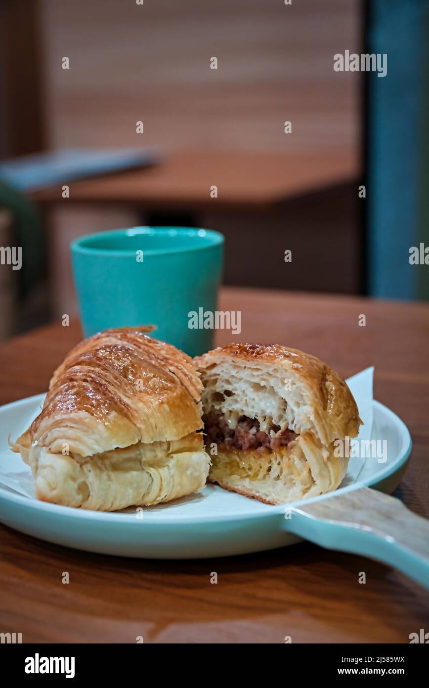 Delicious croissant with meat filling, breakfast in the restaurant ...