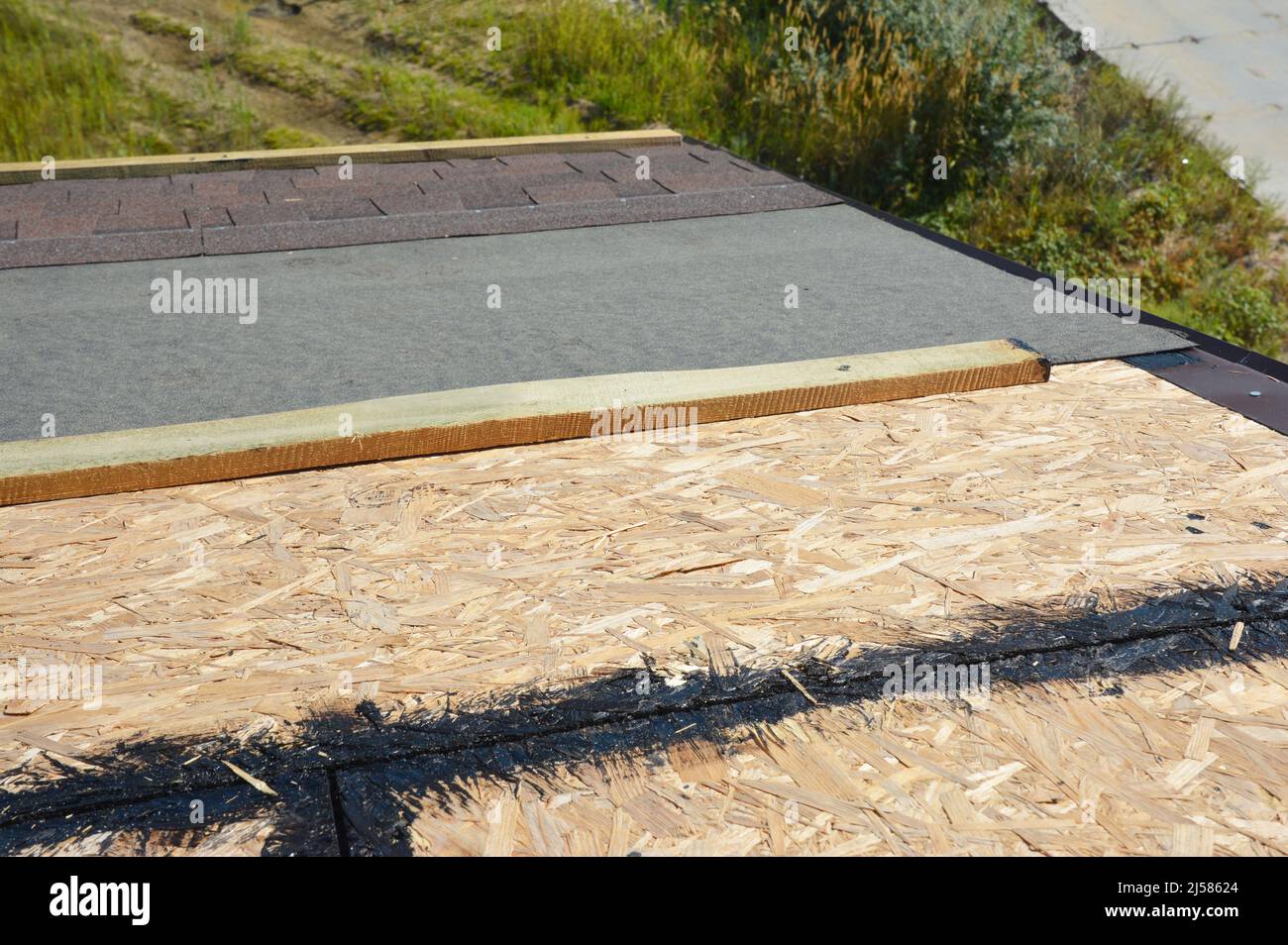 Asphalt shingles installing on house construction roof with all details ...