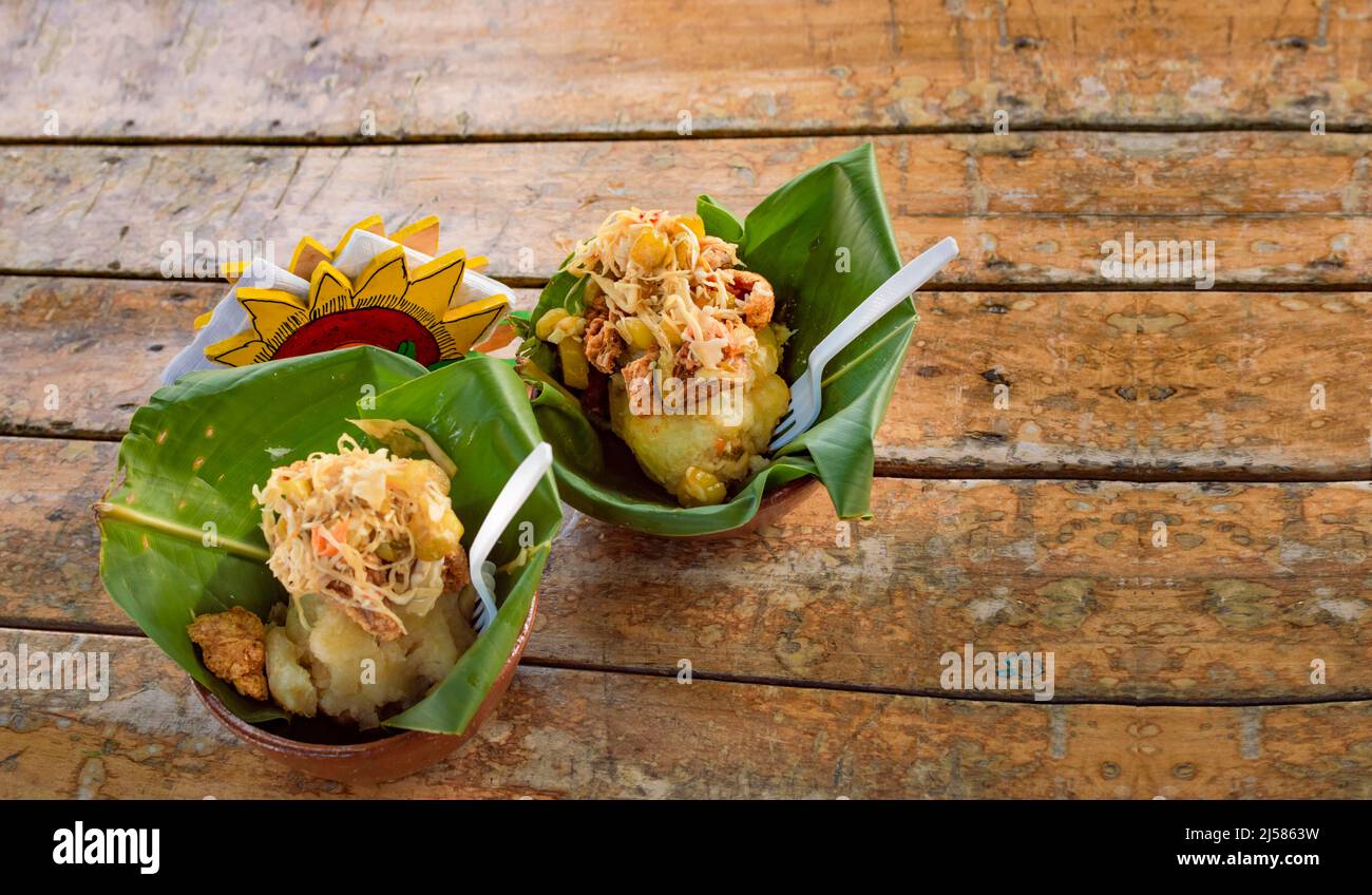 Vigoron with leaves served on a wooden table, two vigorones served on ...