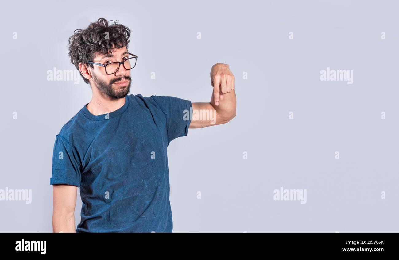 Friendly bearded man pointing down on isolated background, friendly guy ...