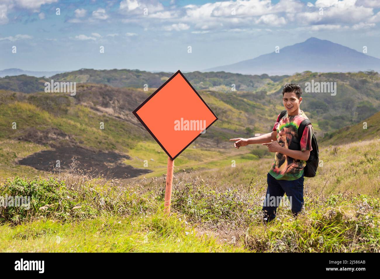 A guy pointing at a billboard, a guy pointing at a signpost Stock Photo ...