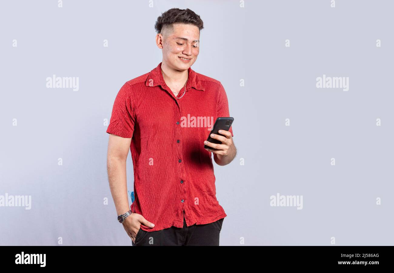 Handsome guy happy with his cell phone, young latin man happy with his ...