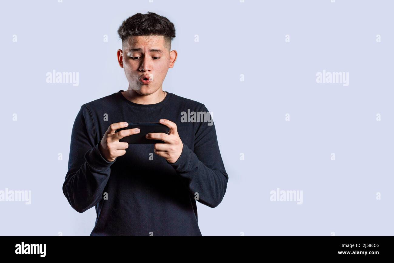 Man holding cell phone horizontally, Guy gasping and playing games on ...