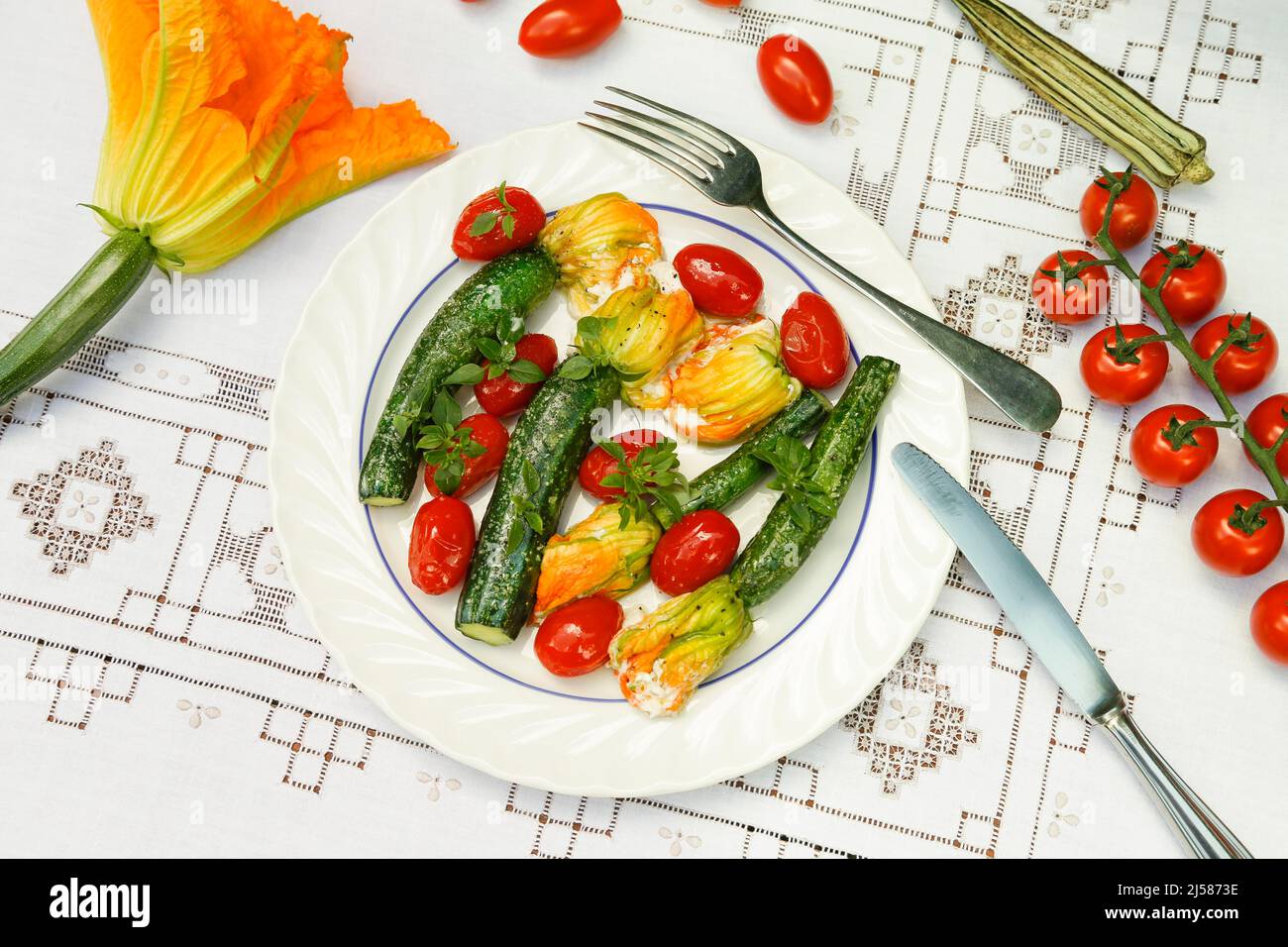Southern German cuisine, stuffed courgette flowers sauteed on plate ...