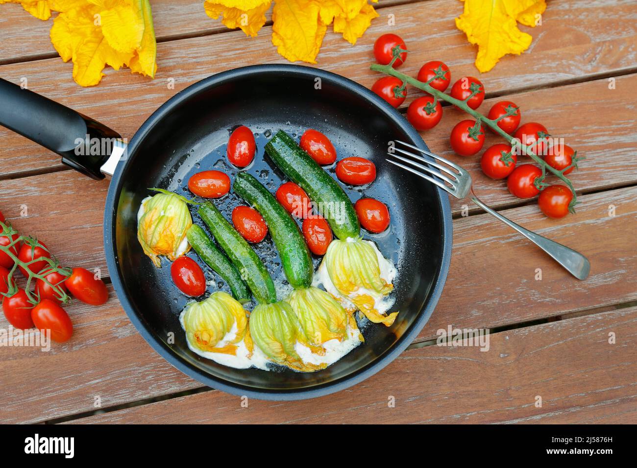 Southern German cuisine, stuffed courgette flowers sauteed in pan ...