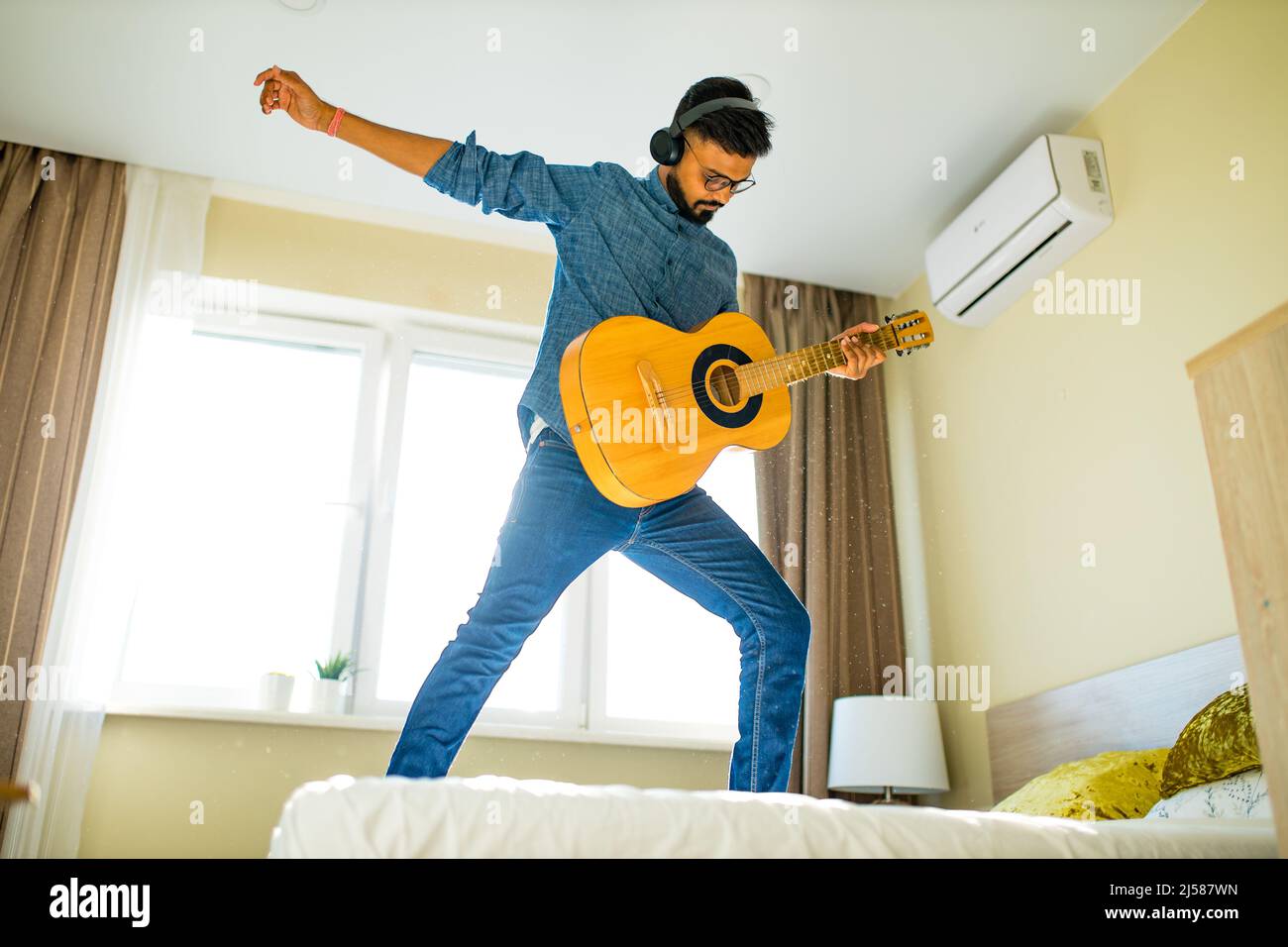 Handsome young man playing guitar hi-res stock photography and images ...