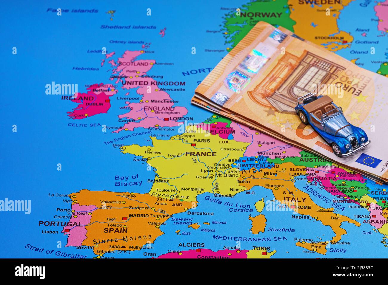 Convertible car and euro banknotes on a map of Europe Stock Photo - Alamy