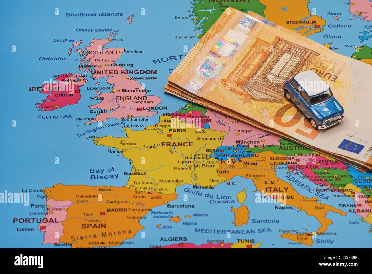 Convertible car and euro banknotes on a map of Europe Stock Photo - Alamy