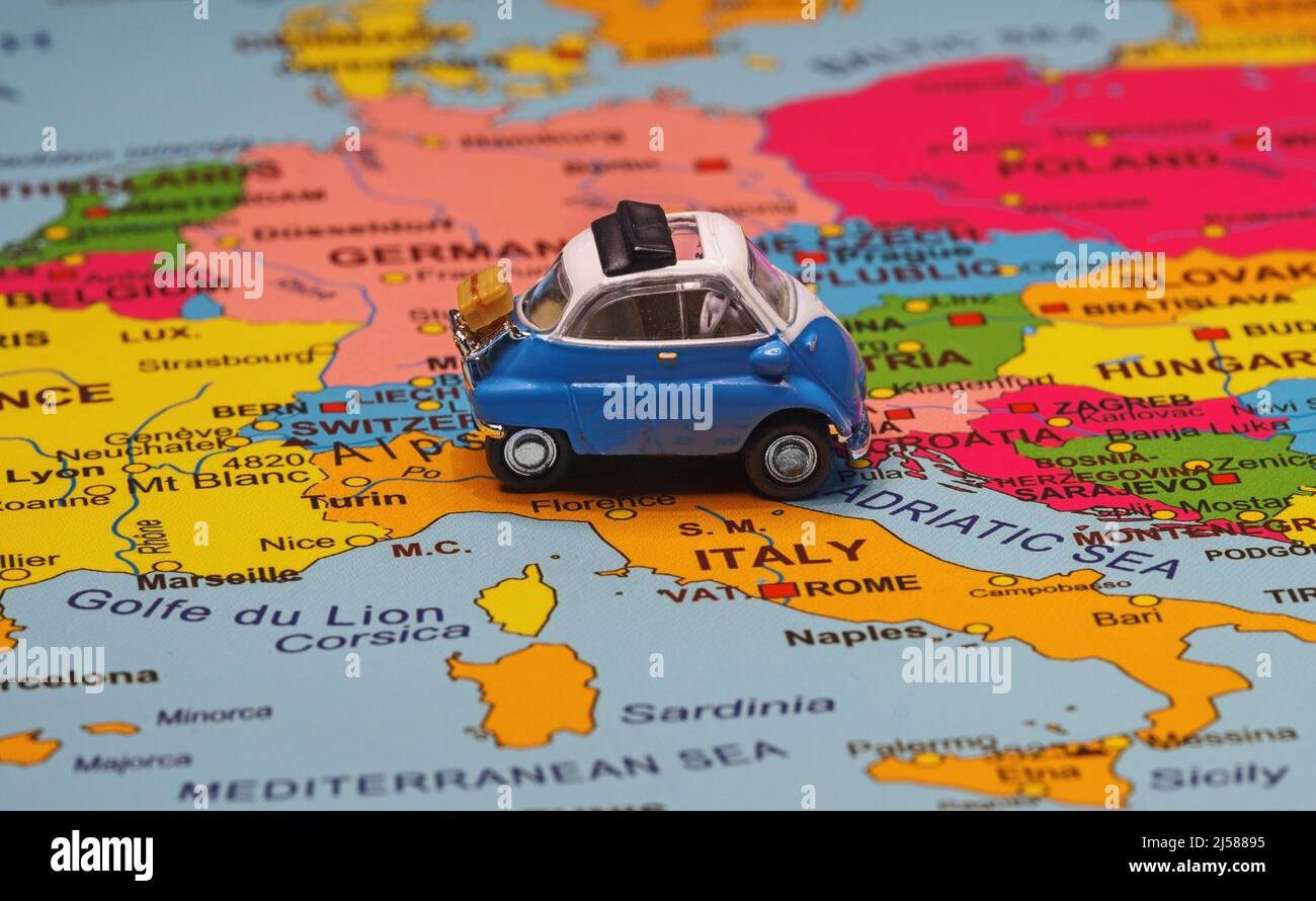 Small toy retro car in the middle of Europe map. Travel by car concept ...