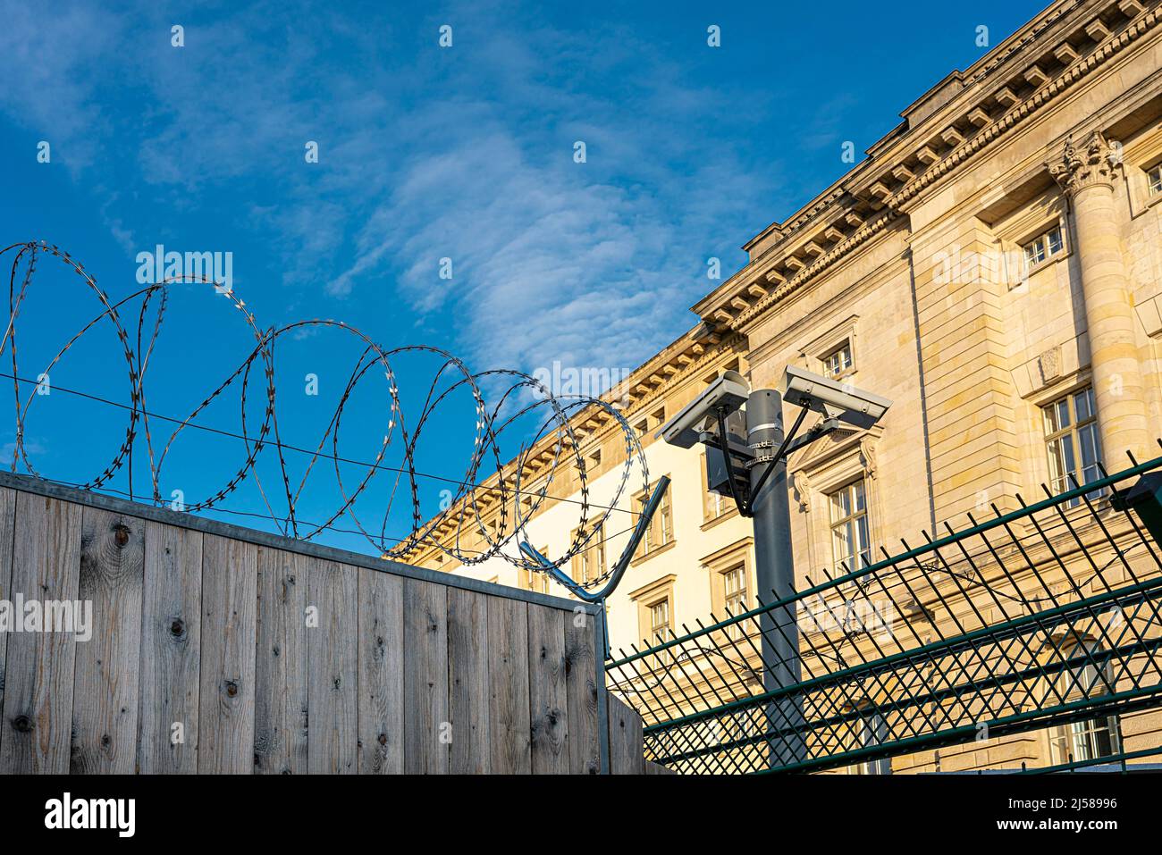Barbed wire and surveillance camera at the entrance to an ...