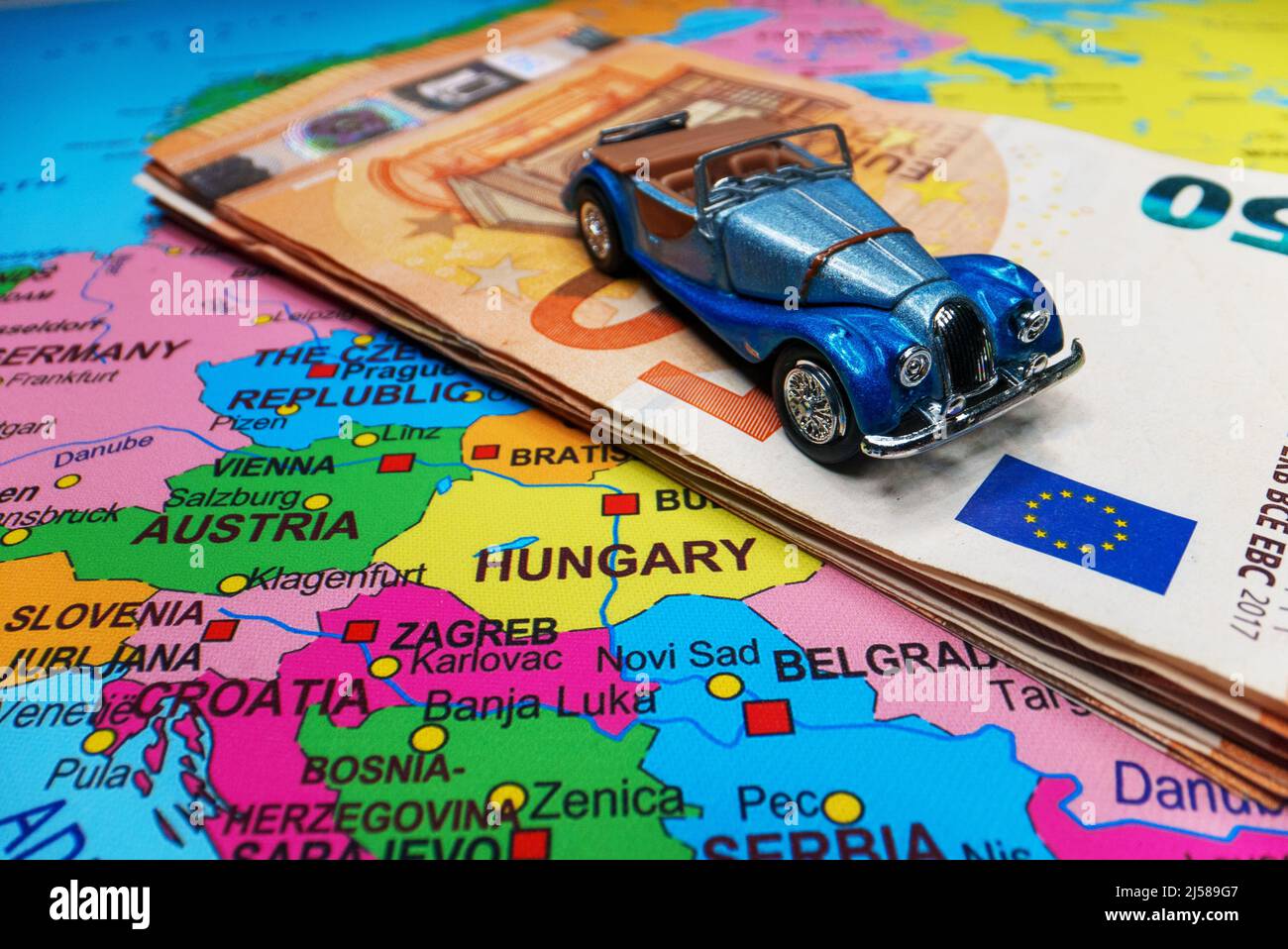 Convertible car and euro banknotes on a map of Europe Stock Photo - Alamy