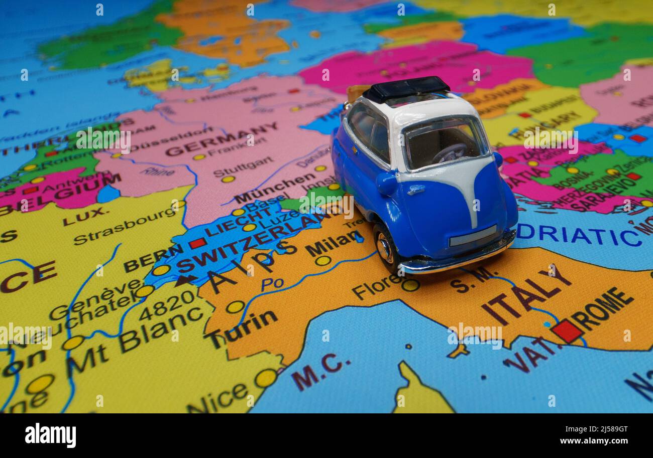 Small toy retro car in the middle of Europe map. Travel by car concept ...