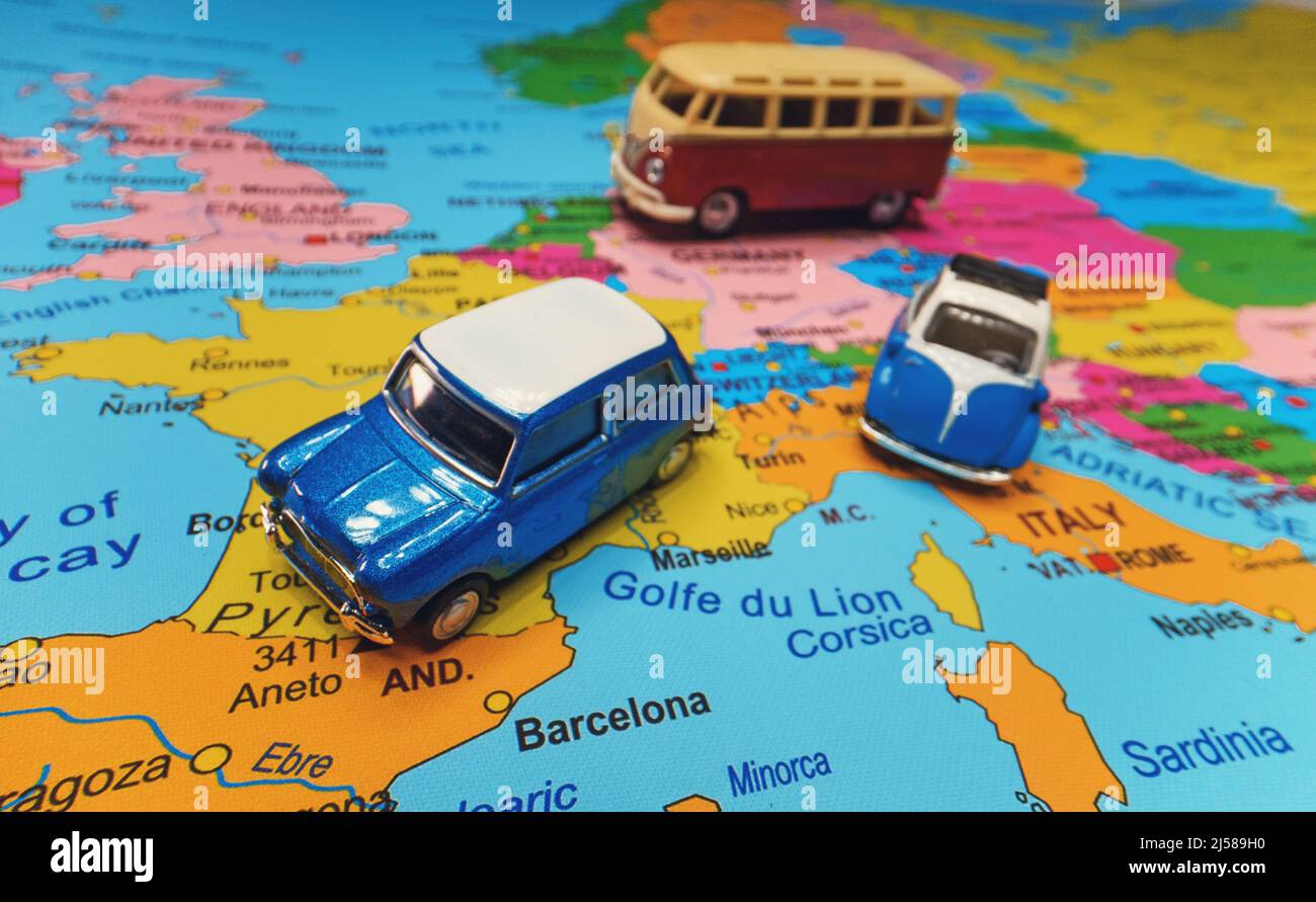 Small toy retro cars in the middle of Europe map. Travel by car concept ...