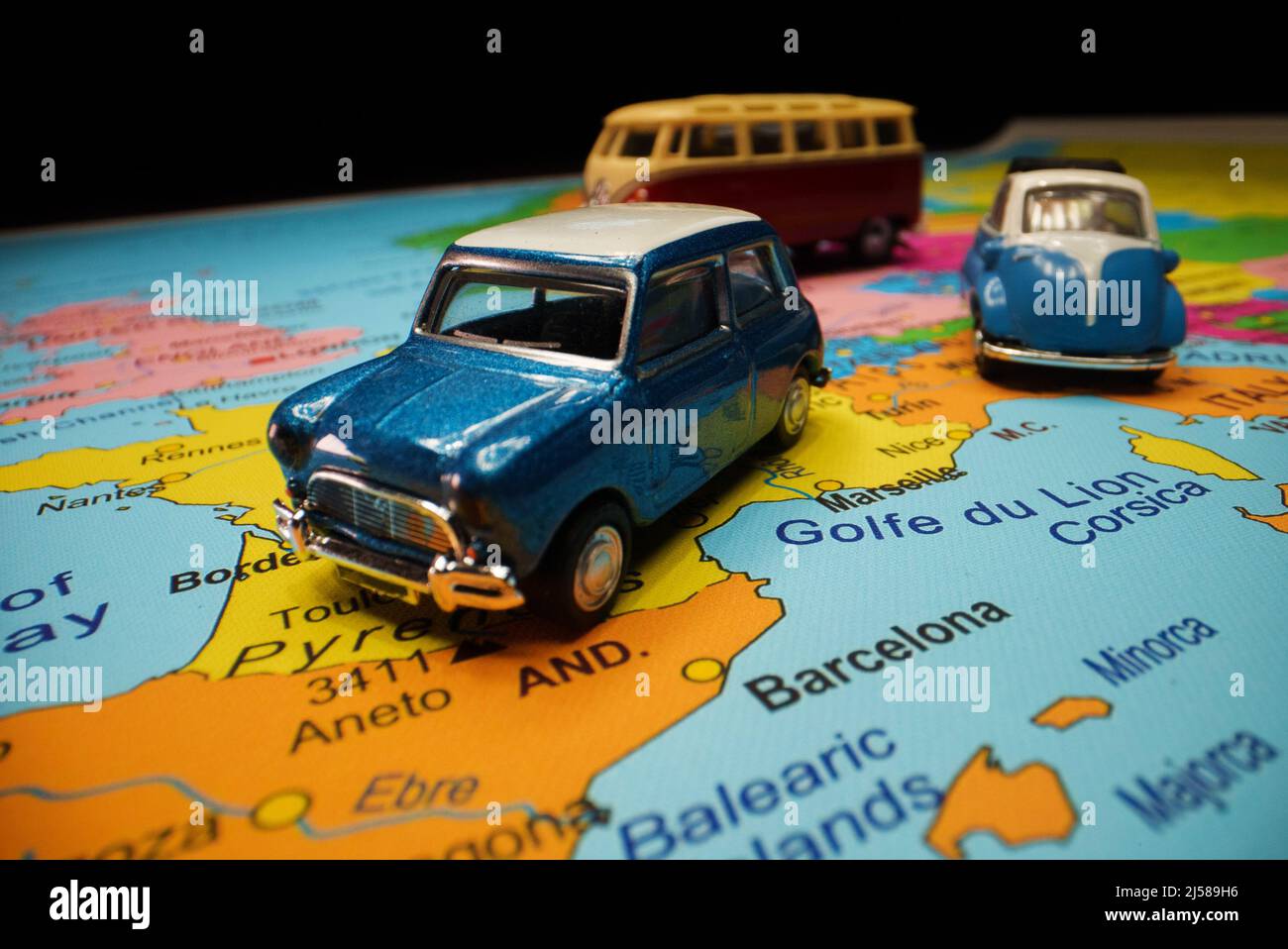 Small toy retro cars in the middle of Europe map. Travel by car concept ...
