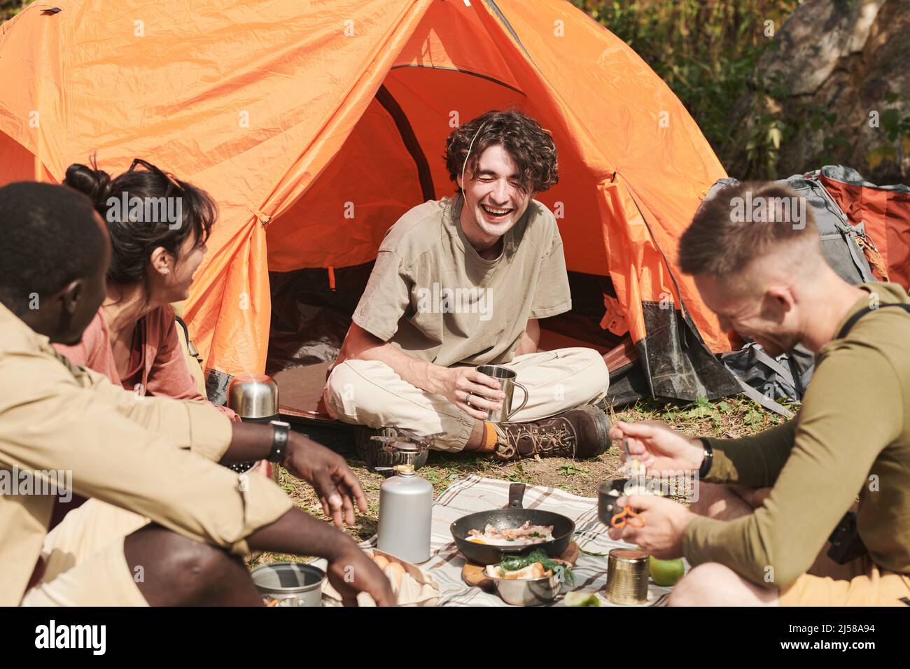 Group of cheerful young multi-ethnic friends of hikers laughing and ...