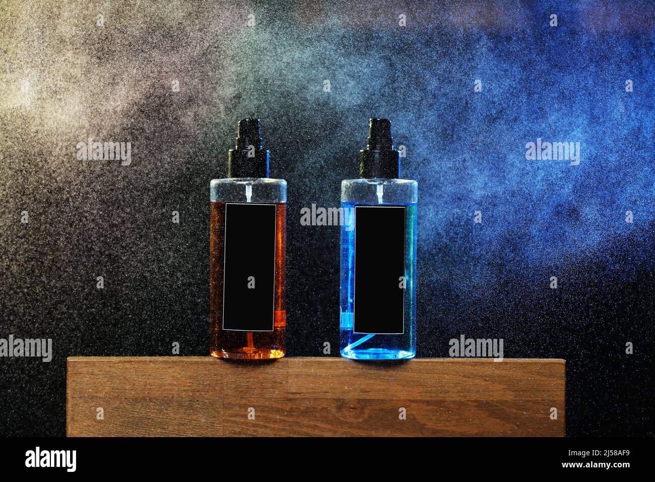 two bottles with yellow and blue liquid. two spray spraying cans on ...