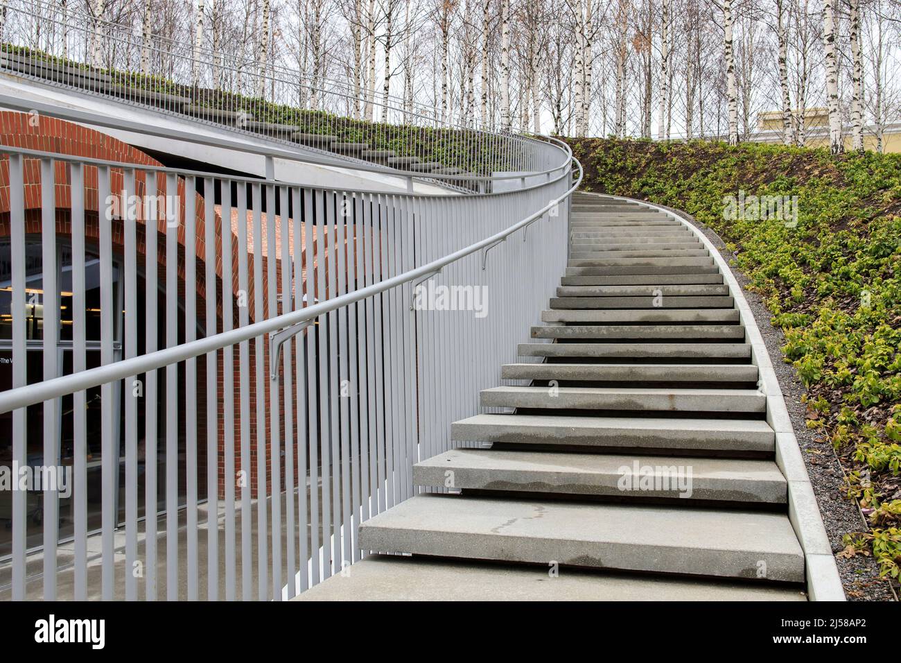 Tall modern winding staircase with railings in a birch grove Stock ...
