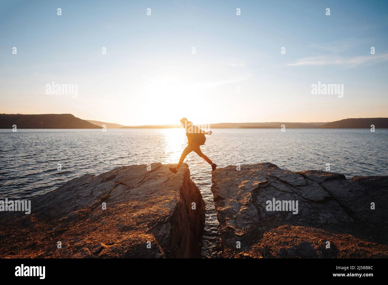 Man jumping rock coast hi-res stock photography and images - Alamy