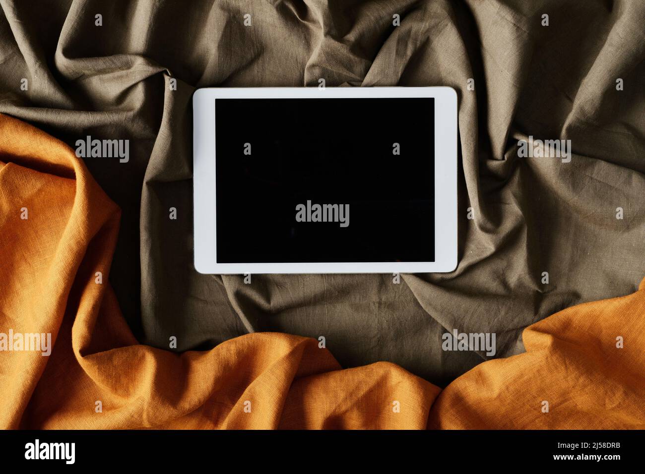 Directly above view of digital tablet with blank screen placed on ...