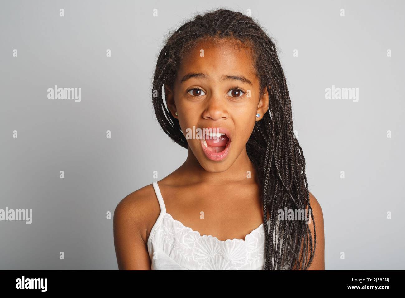 Adorable african little girl on studio white background Stock Photo - Alamy