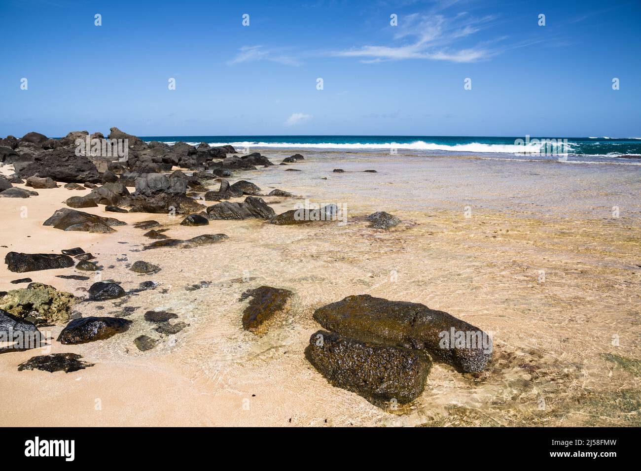 Volcanic basalt boulders on Haena Beach on the Island of Kauai, Hawaii ...