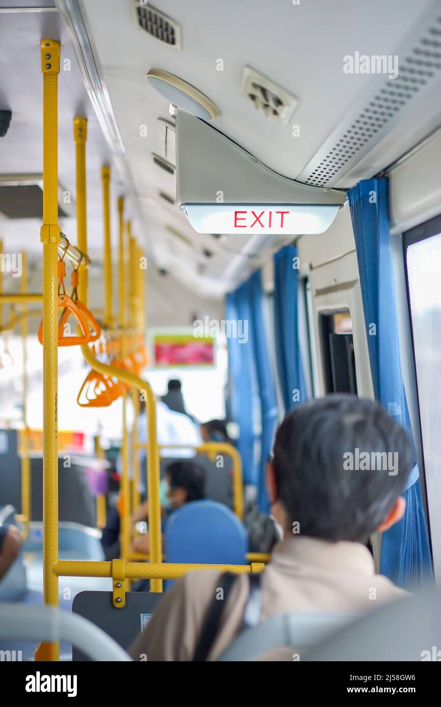 Exit sign light box is hung on the ceiling inside the bus, Thailand ...