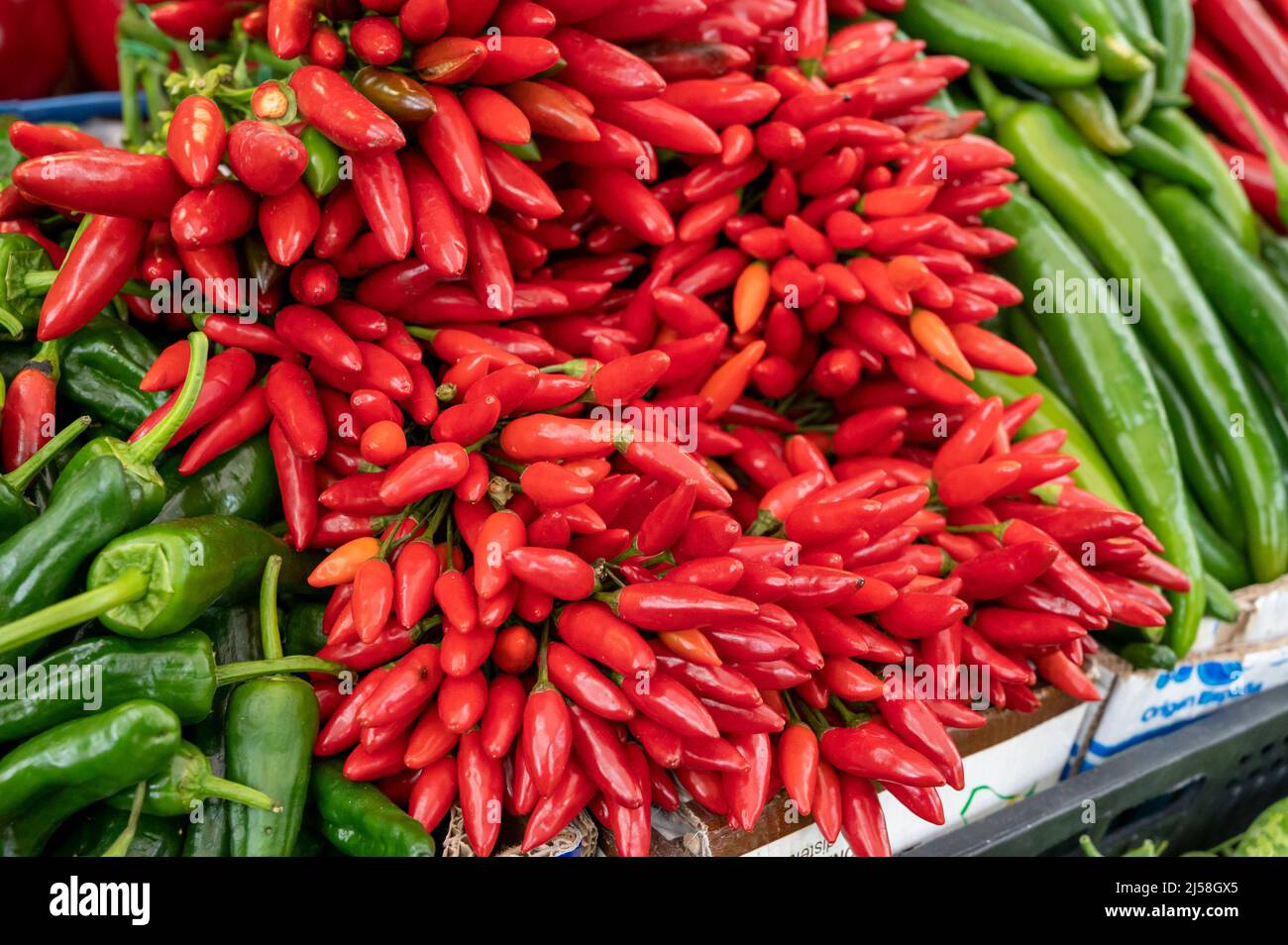 Many fresh red chilli peppers on the market hi-res stock photography ...