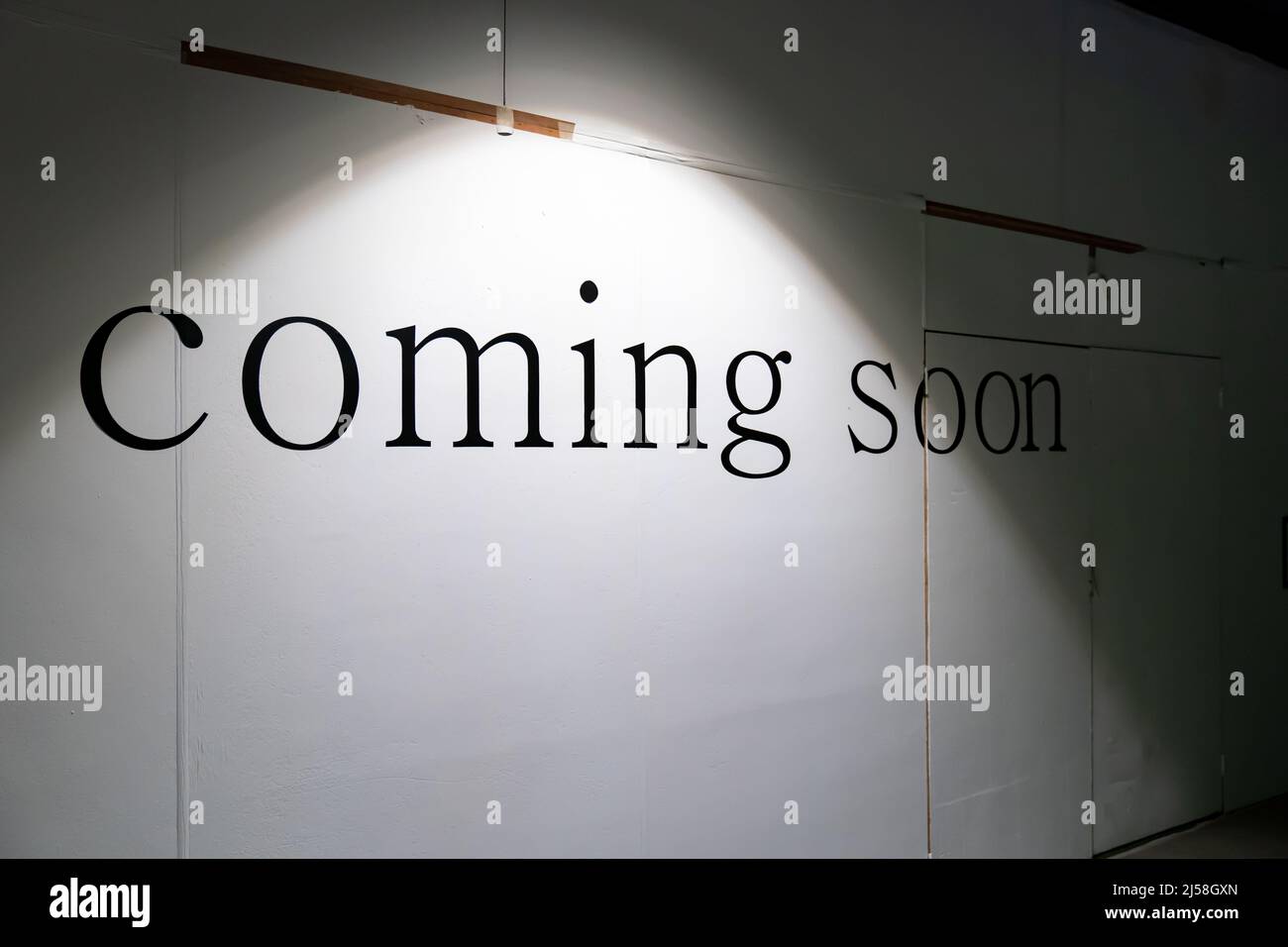 COMING SOON word on white background in the tungsten light on the wood ...