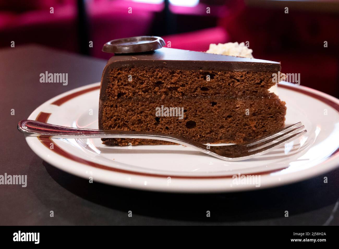 Piece of famous Sachertorte chocolate cake with apricot jam of Austrian ...