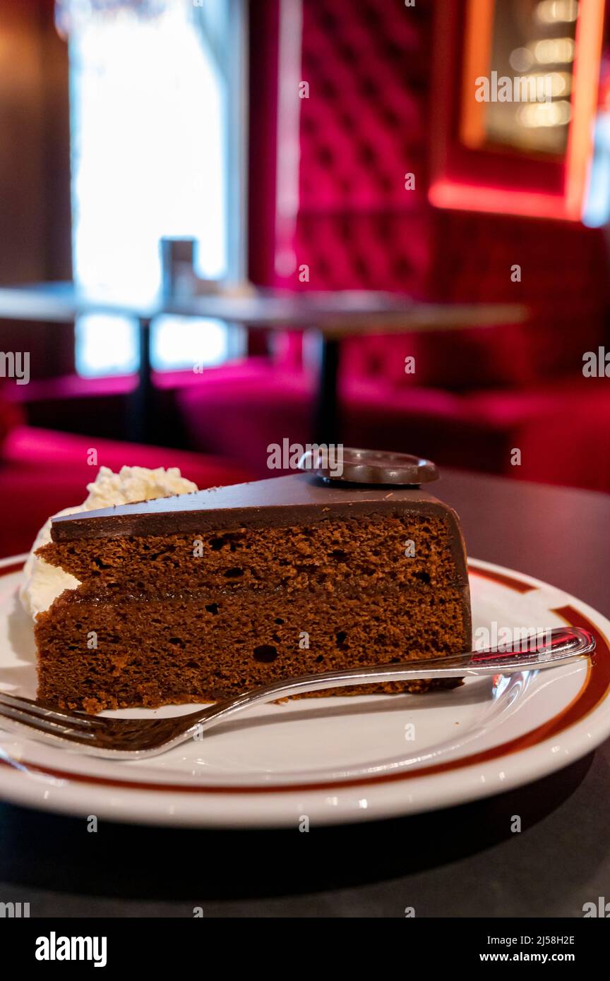 Piece of famous Sachertorte chocolate cake with apricot jam of Austrian ...