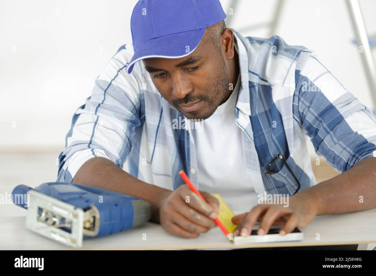 making a mark with a pencil in a wood strip Stock Photo - Alamy
