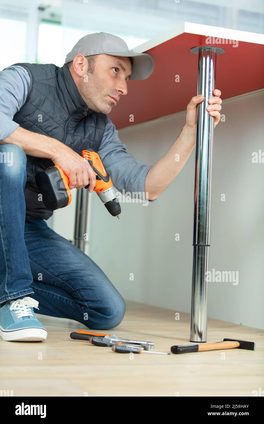 man with an electric screwdriver in his hand Stock Photo - Alamy