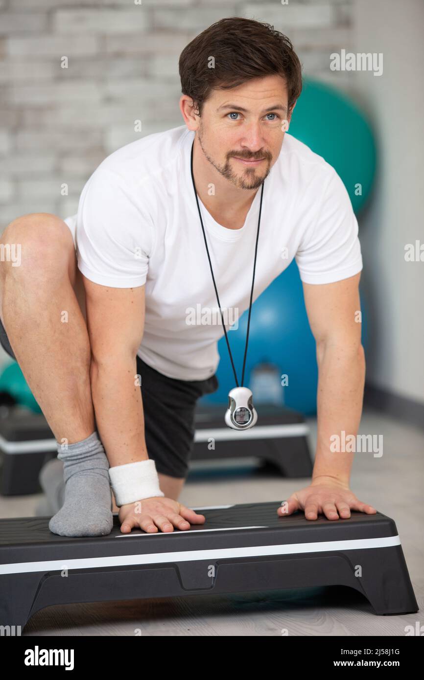 man is stepping on step machines Stock Photo - Alamy