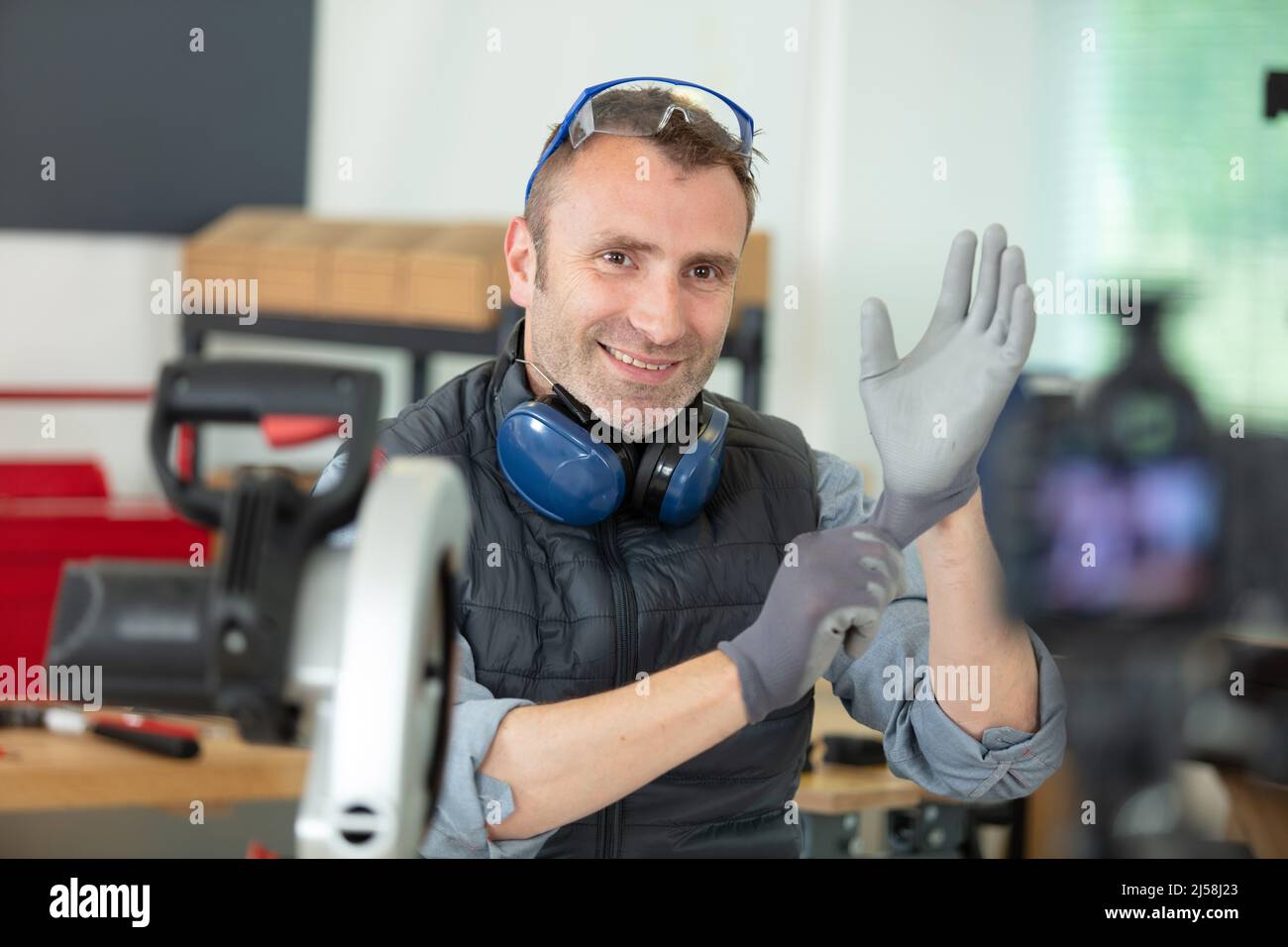 happy repairer showing the importance of protective gloves Stock Photo ...