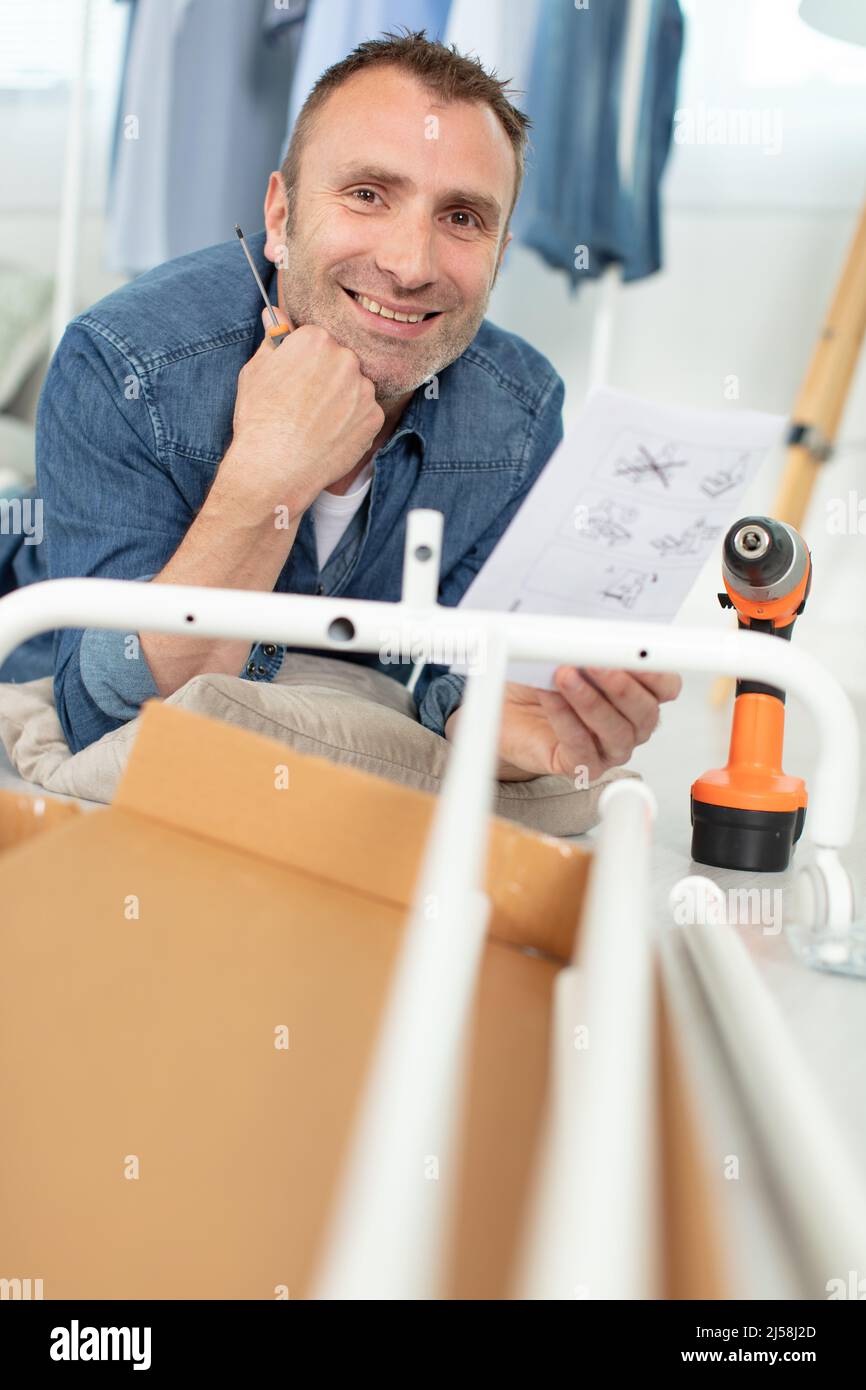 man smiling with the drill Stock Photo - Alamy