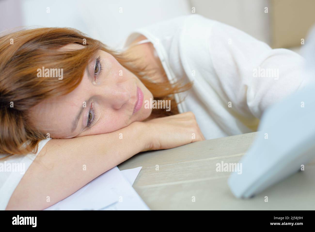 Woman slouching at desk hi-res stock photography and images - Alamy