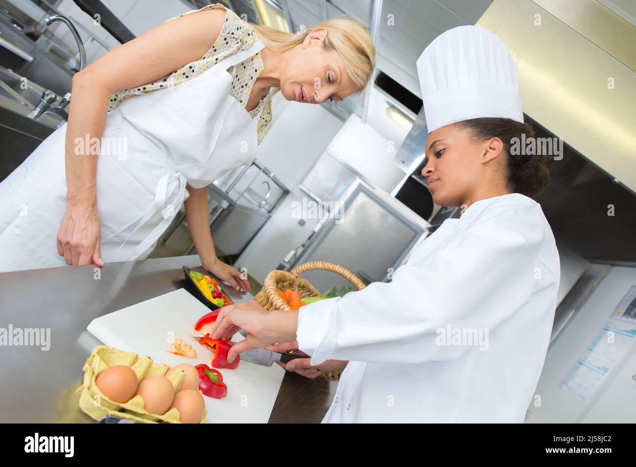 two female chefs preparing food for the restaurant Stock Photo - Alamy