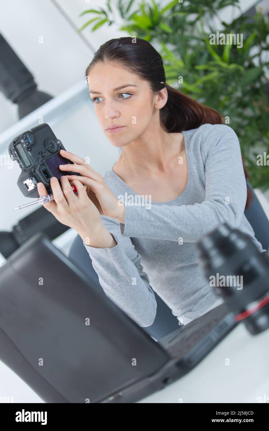 a female photographer checking camera Stock Photo - Alamy