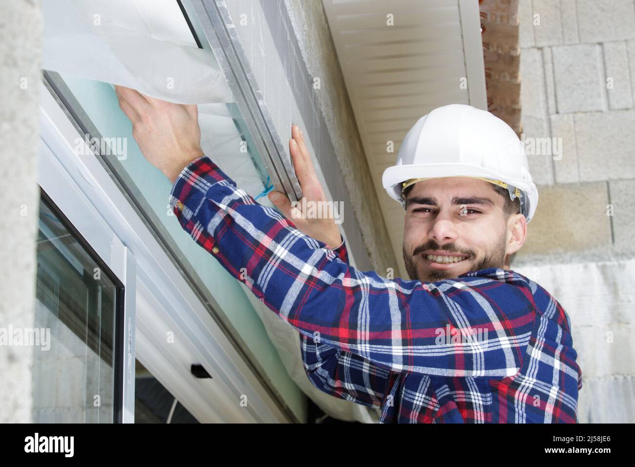 facade builder installing tile on wall Stock Photo - Alamy